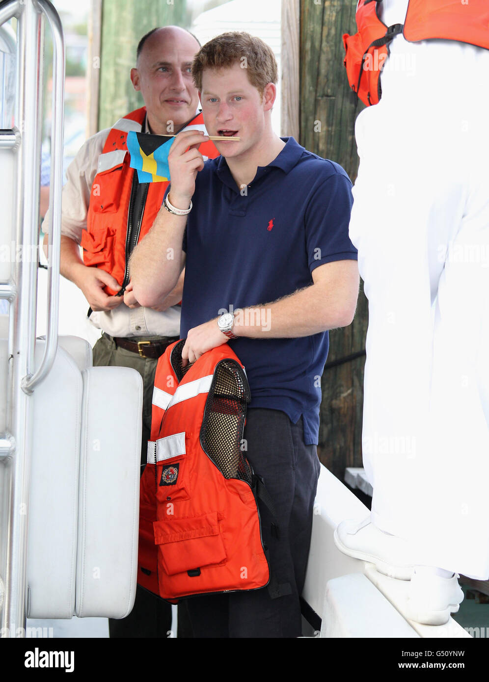Prince Harry puts on his life jacket as he leaves Harbour Island in ...