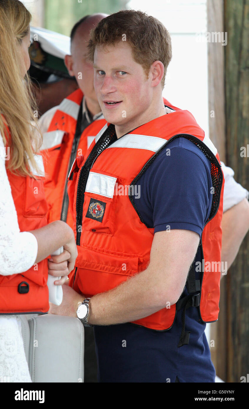 Prince Harry puts on his life jacket as he leaves Harbour Island in ...