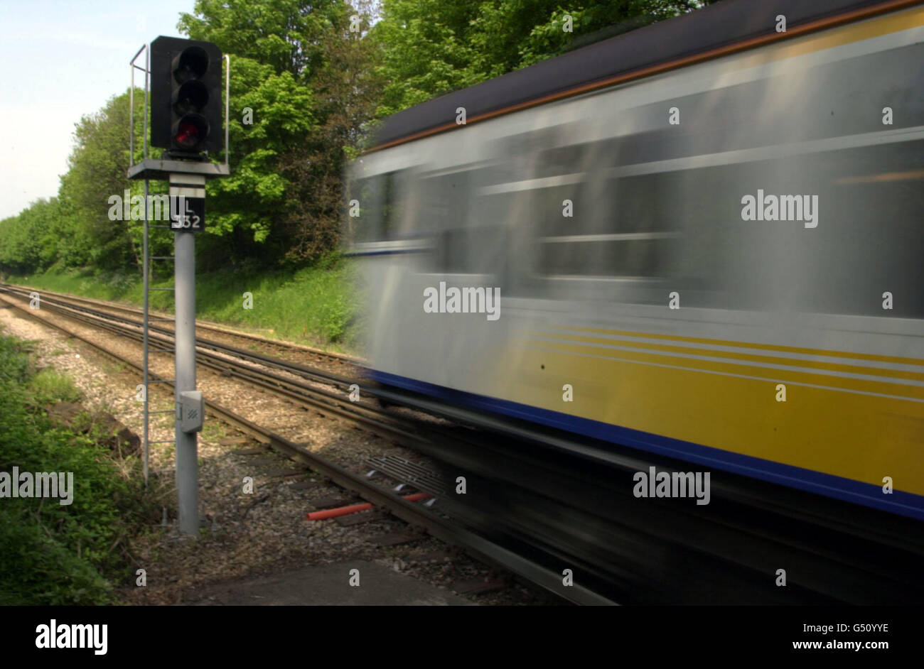 A train passes a red light and magnetic sensor in centre of the track ...