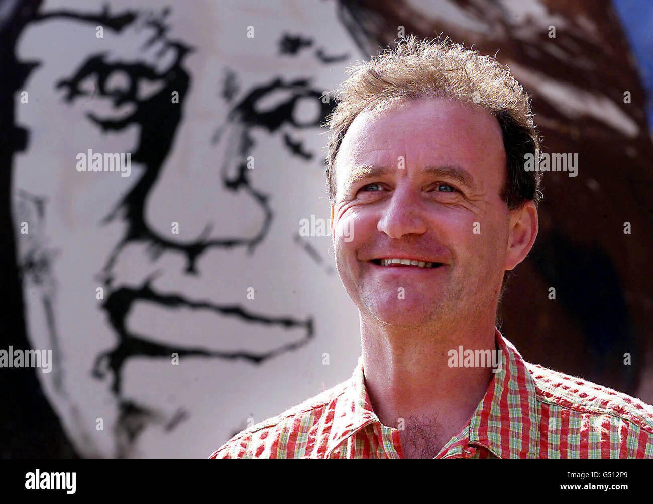 Sinn Fein's behind-the-scenes strategist Jim Gibney beside a new mural ...