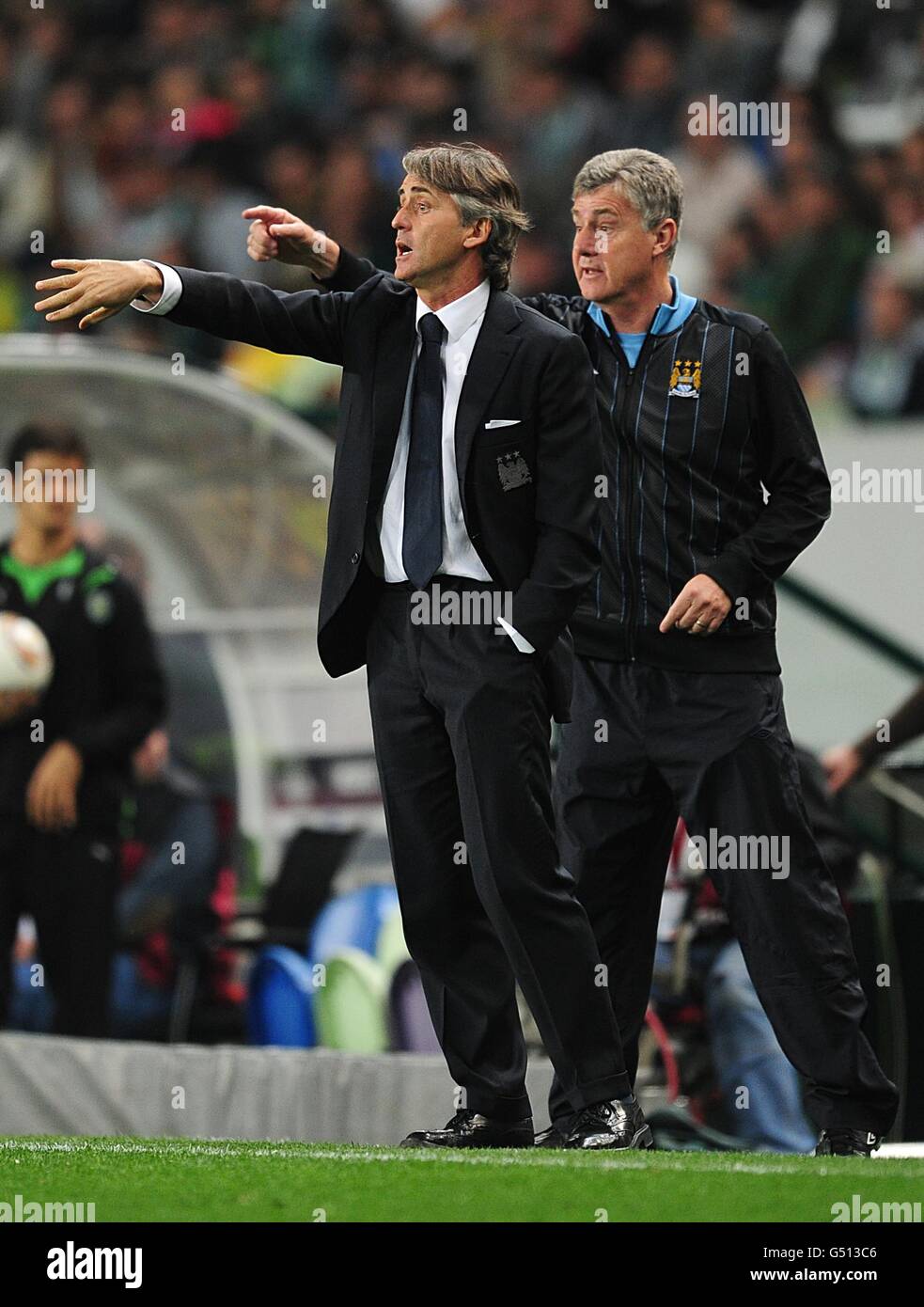 Manchester City manager Roberto Mancini (left) and his assistant Brian ...