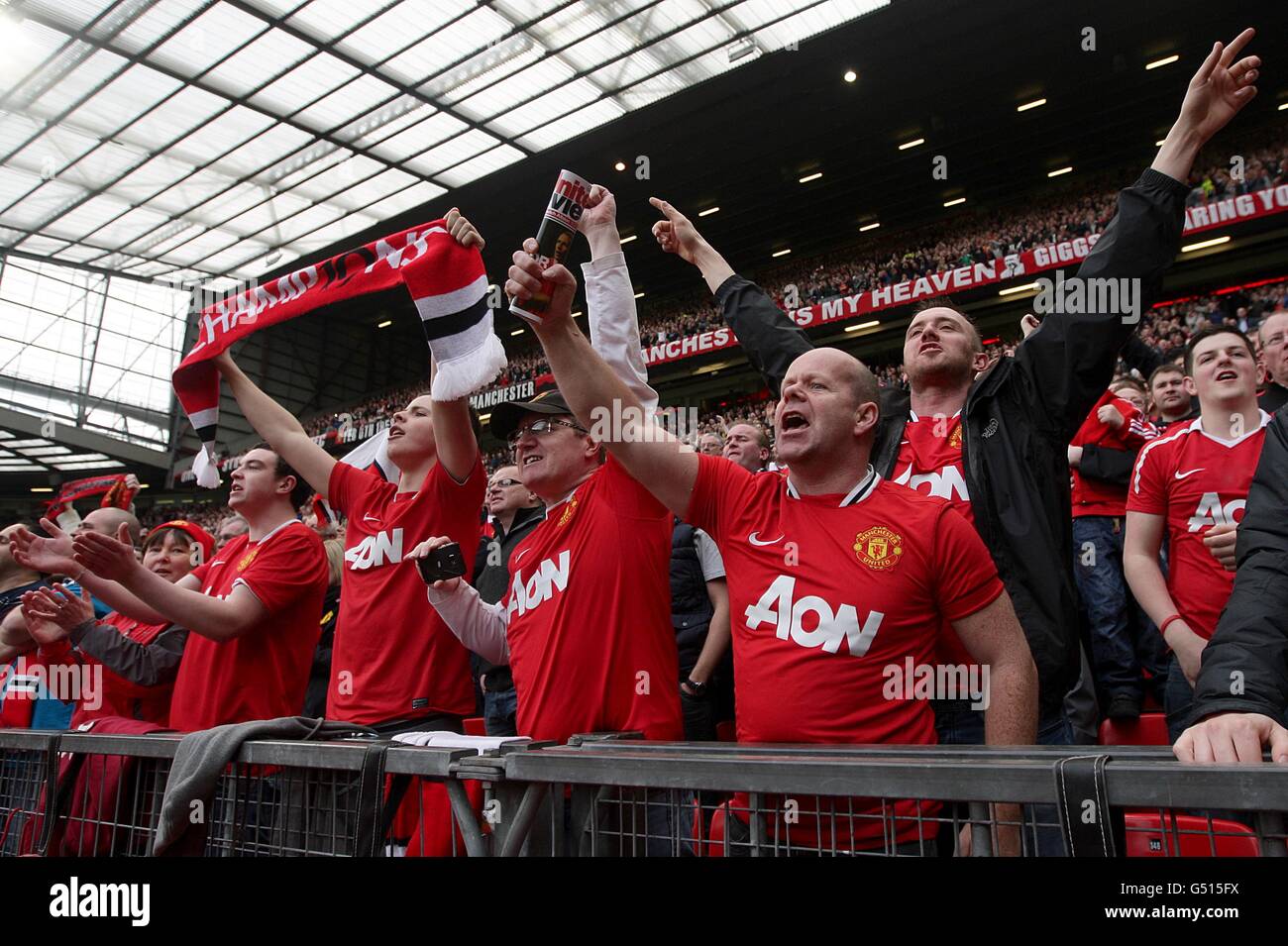 Manchester United fans celebrate in the stands after the final whistle ...