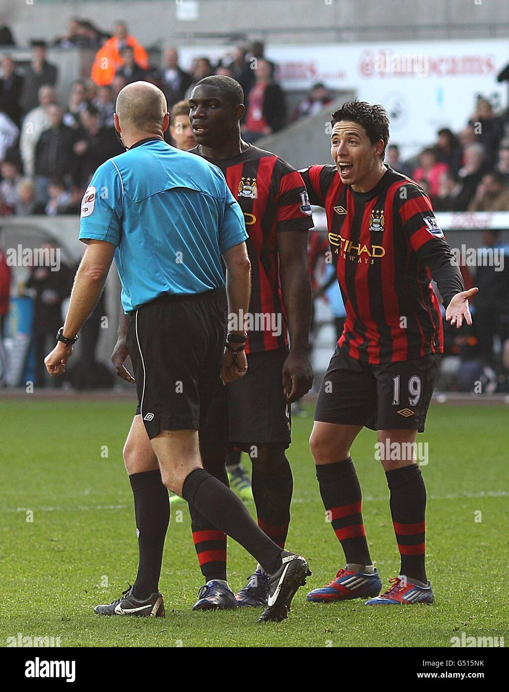 Manchester City's Micah Richards (centre) and Samir Nasri (right) argue ...