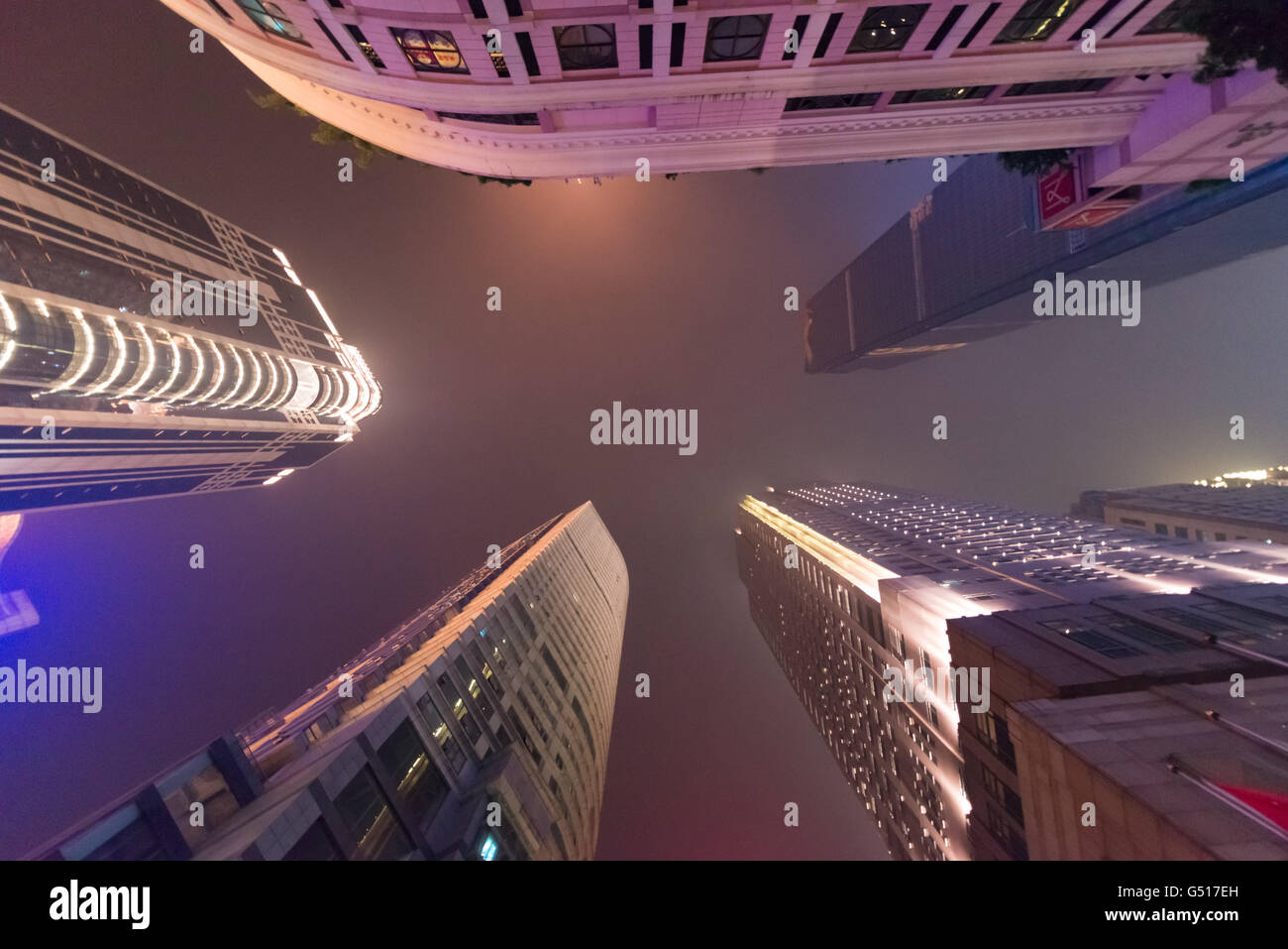 China, Chongqing, high-rise buildings at night in frog-perspective ...