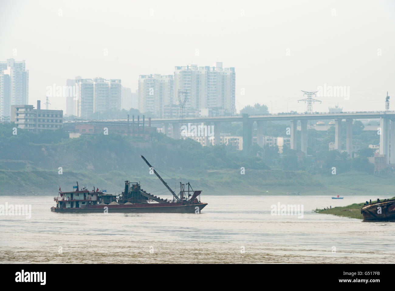China, Chongqing, ship on the Jialing River with the high-rise ...