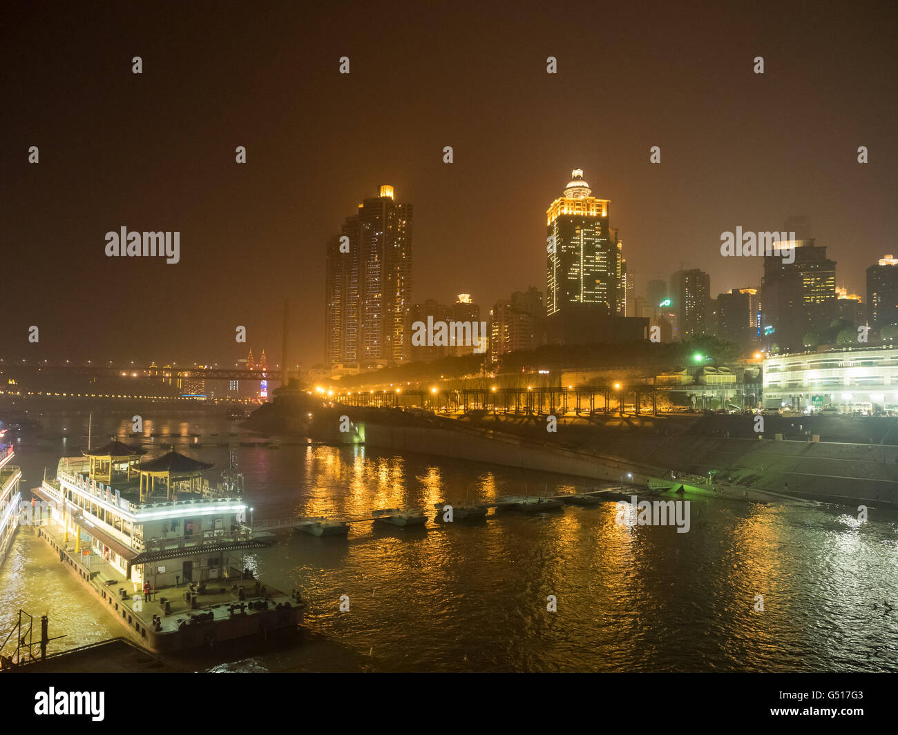 China, Chongqing, pier for Yangzte river cruise ships at night with ...