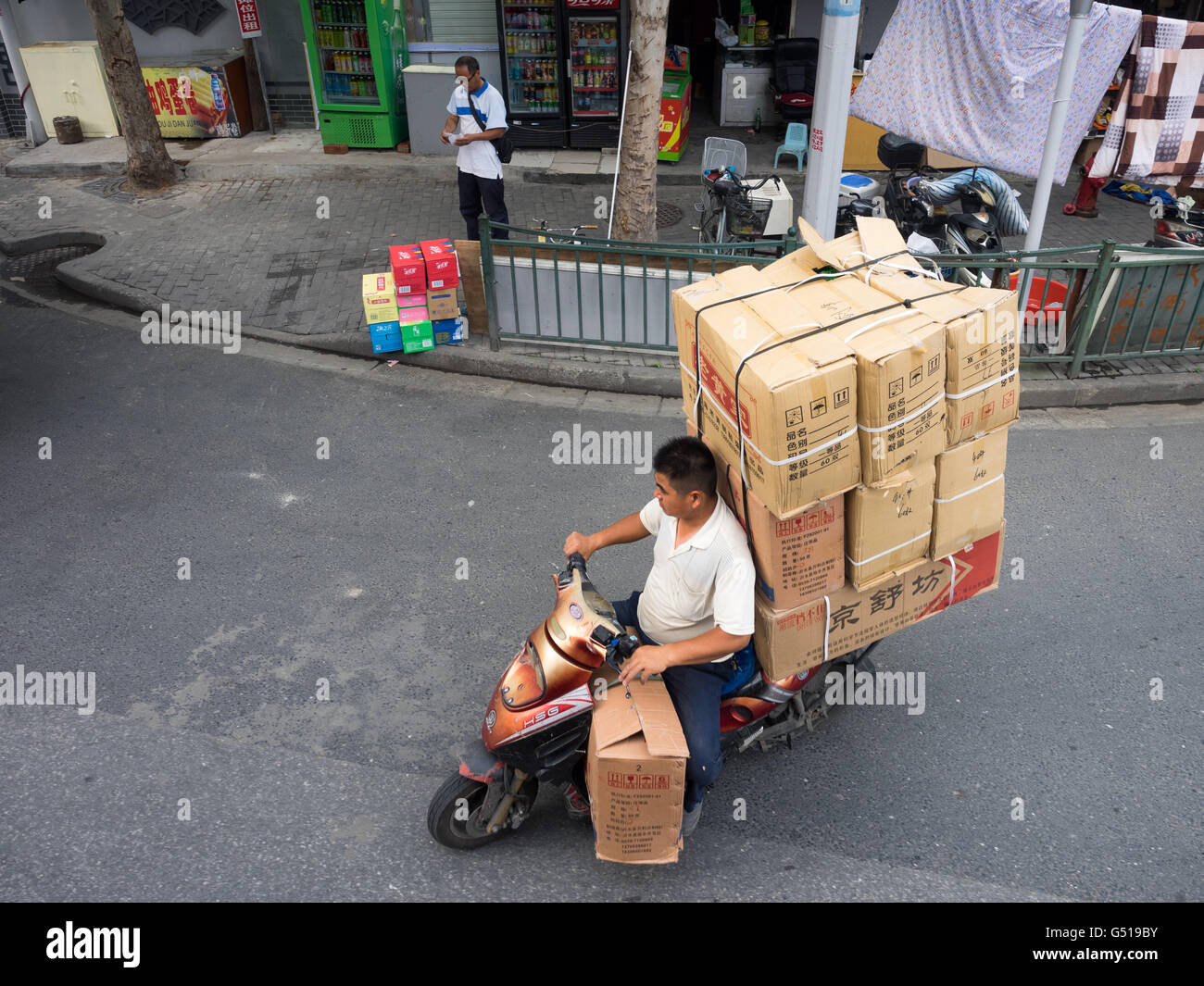 China, Shanghai, Heavy loaded scooter on the streets of Shanghai Stock ...