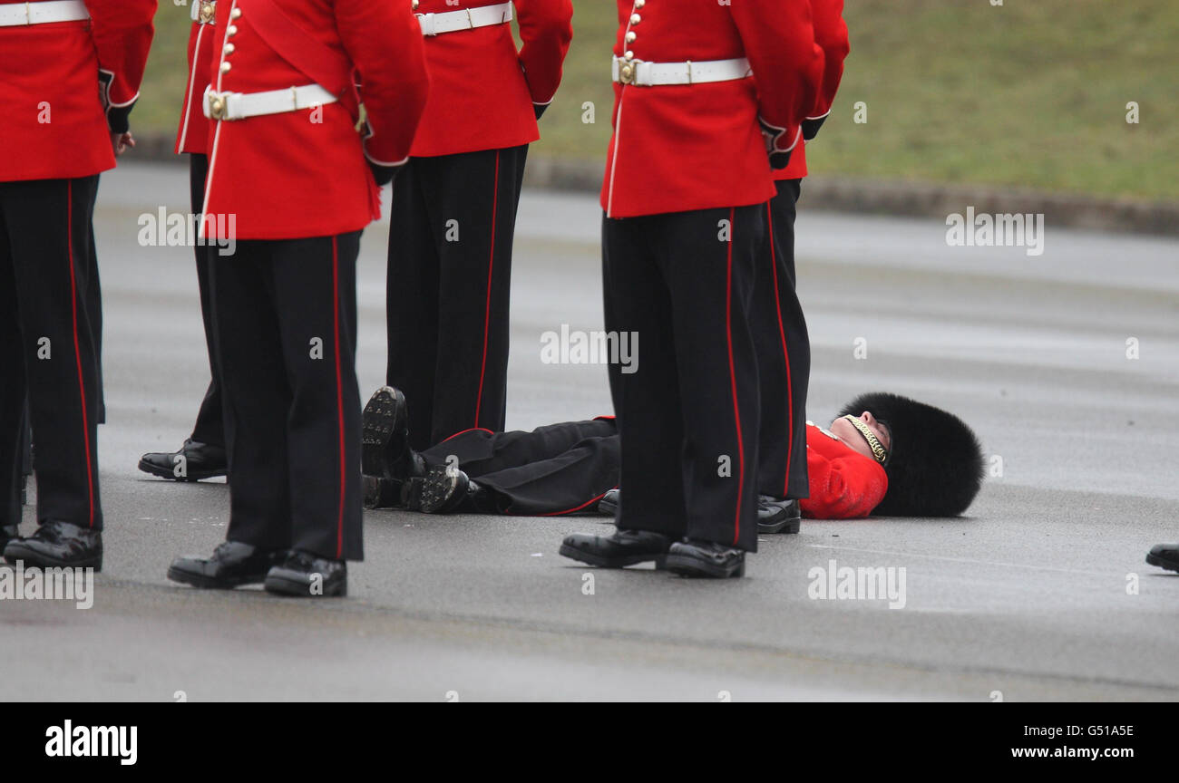 A member of The Irish Guards collapses before the arrival of the ...