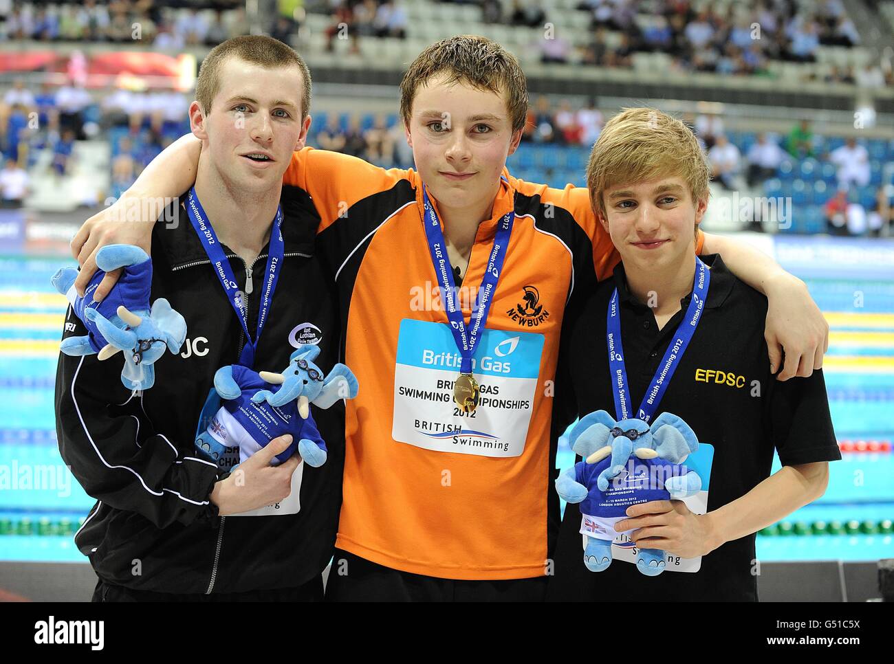 Rafael Bagott (centre) poses with his gold medal alongside ...