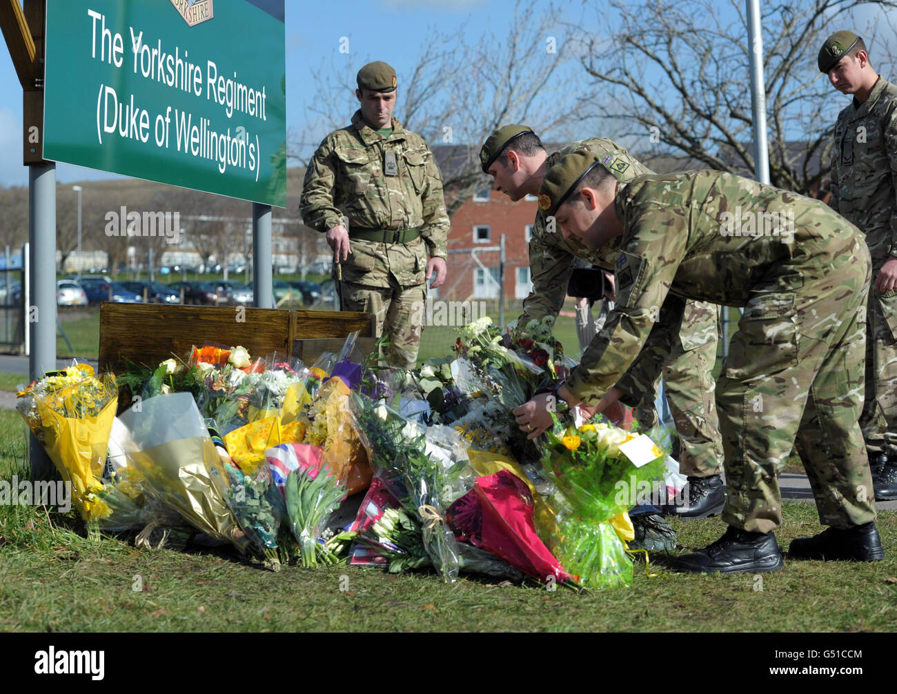 Soldiers rearrange floral tributes at the 3rd Battalion The Yorkshire ...