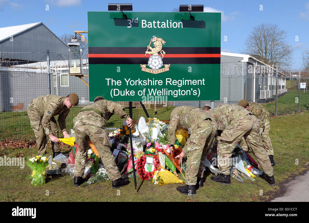 Soldiers rearrange floral tributes at the 3rd Battalion The Yorkshire ...