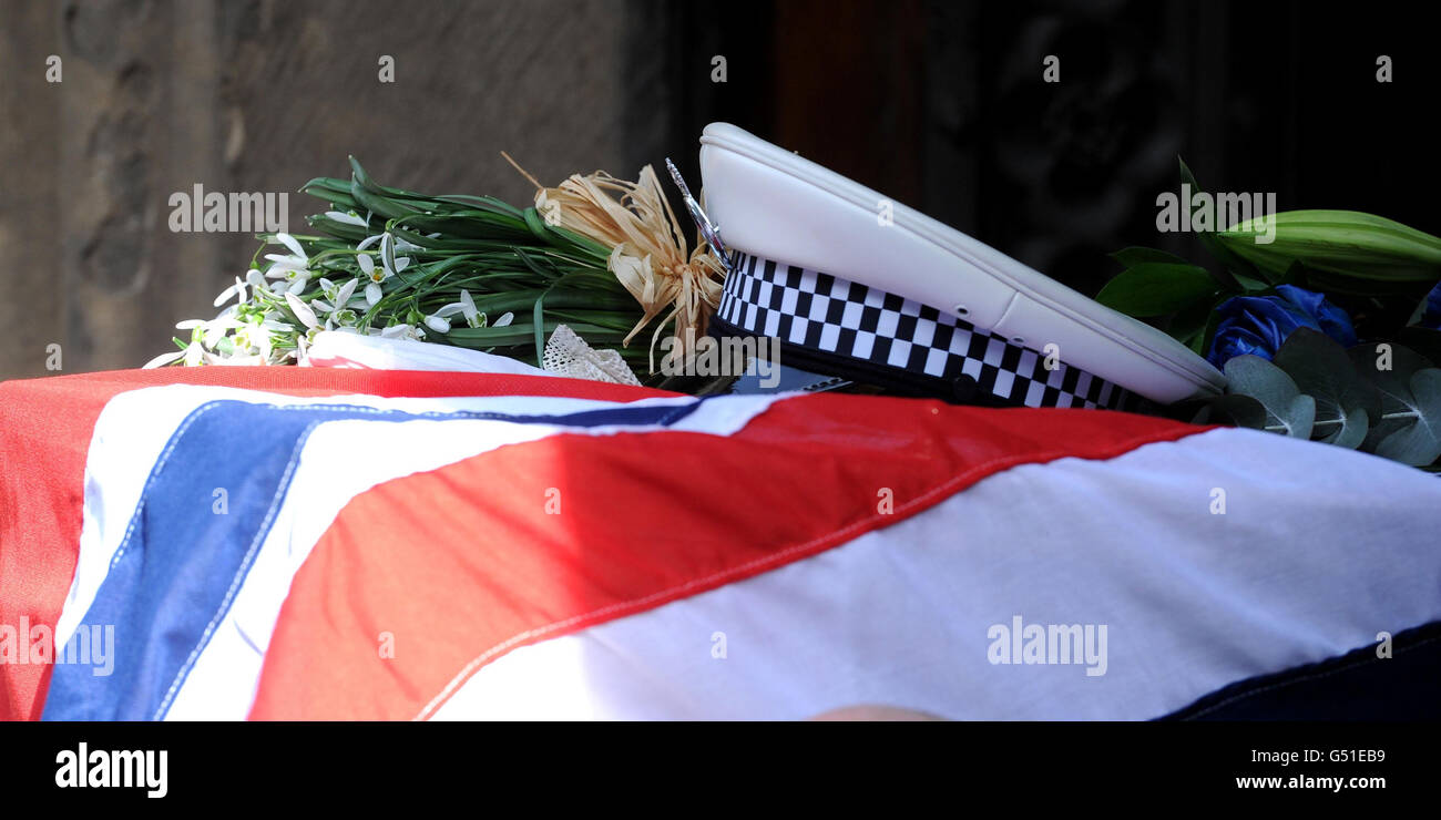 A police hat on top of the coffin of Pc David Rathband, as it arrives ...