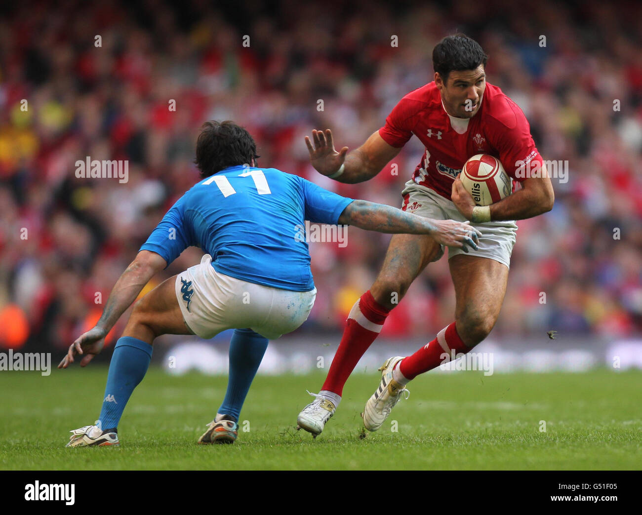 Wales' Mike Phillips is tackled by Italy's Luke Mclean (left) during ...