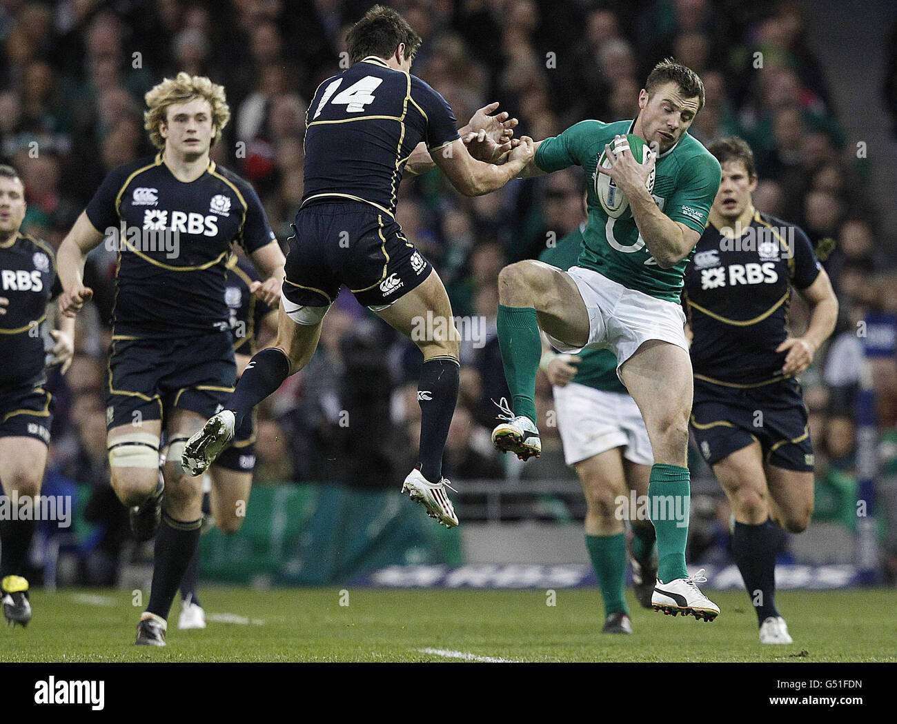 Ireland's Tommy Bowe and Scotland's Lee Jones in action during the RBS ...