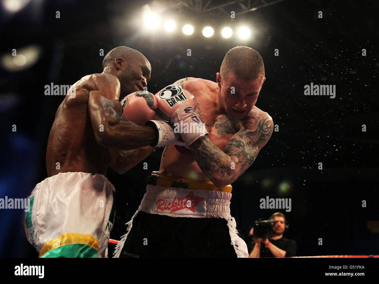 Glasgow's Ricky Burns in action against Namibia's Paulus Moses (left ...