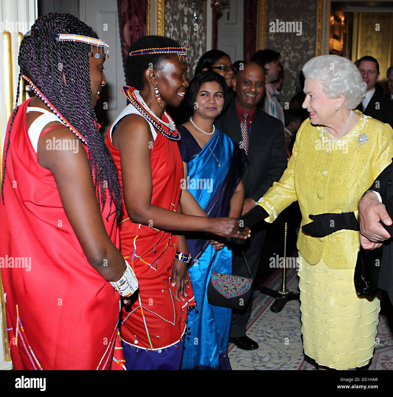 Queen Elizabeth II speaks with Lucie Shigikile (second left) and her ...