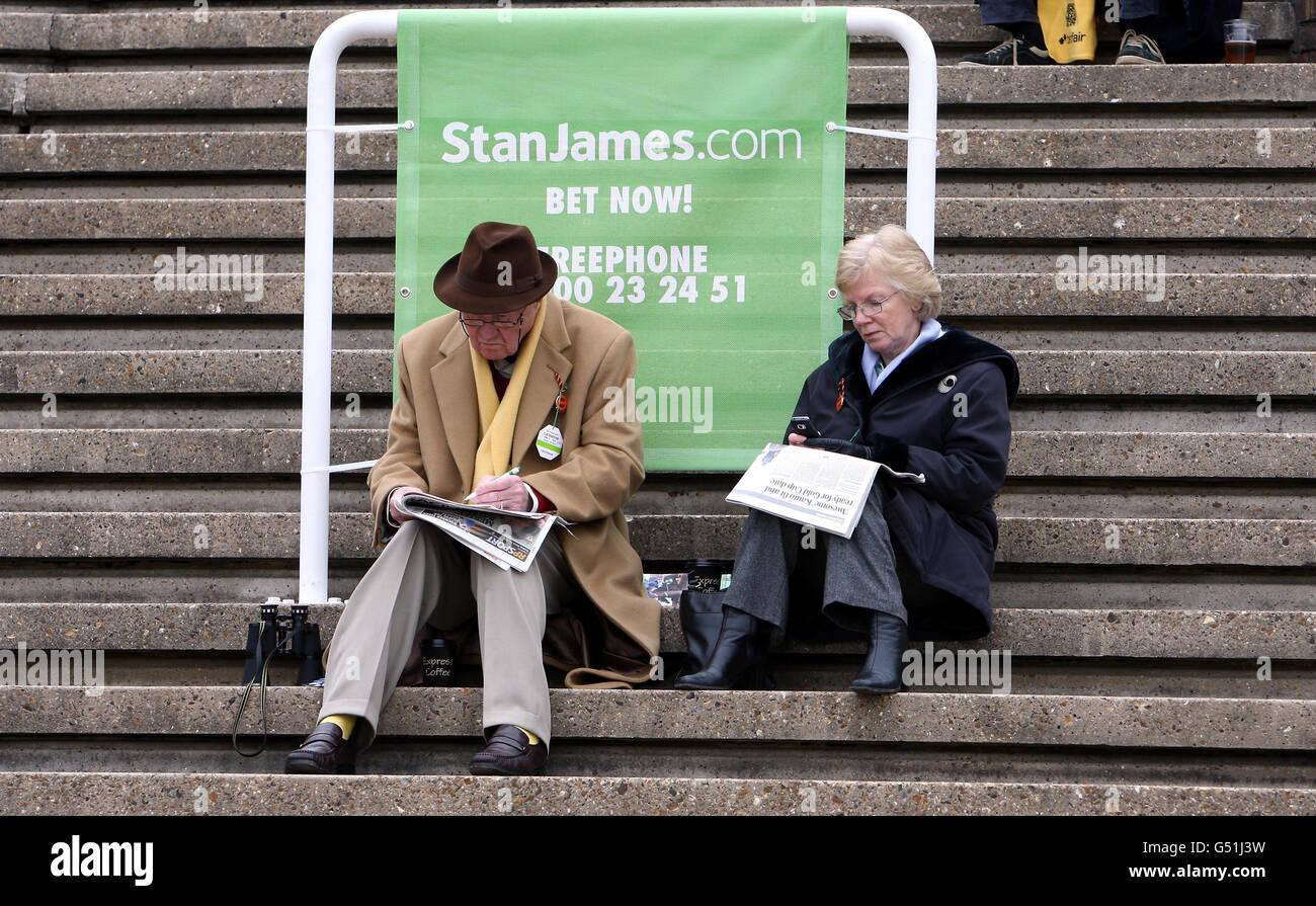 Punters study form before the start of the first race during day one of ...