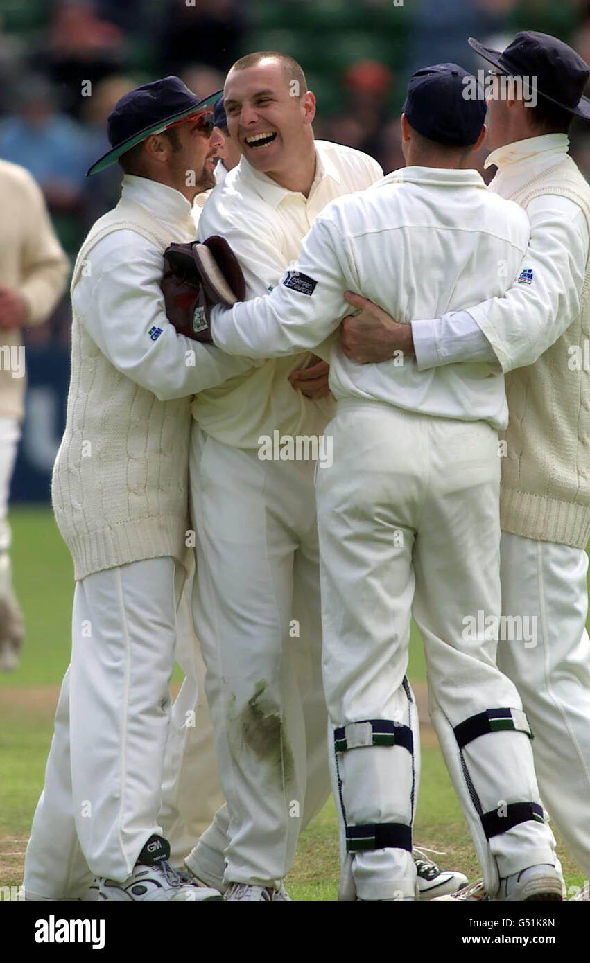 Bowler Alex Wharf (2nd left) is congratulated by his Glamorgan team ...