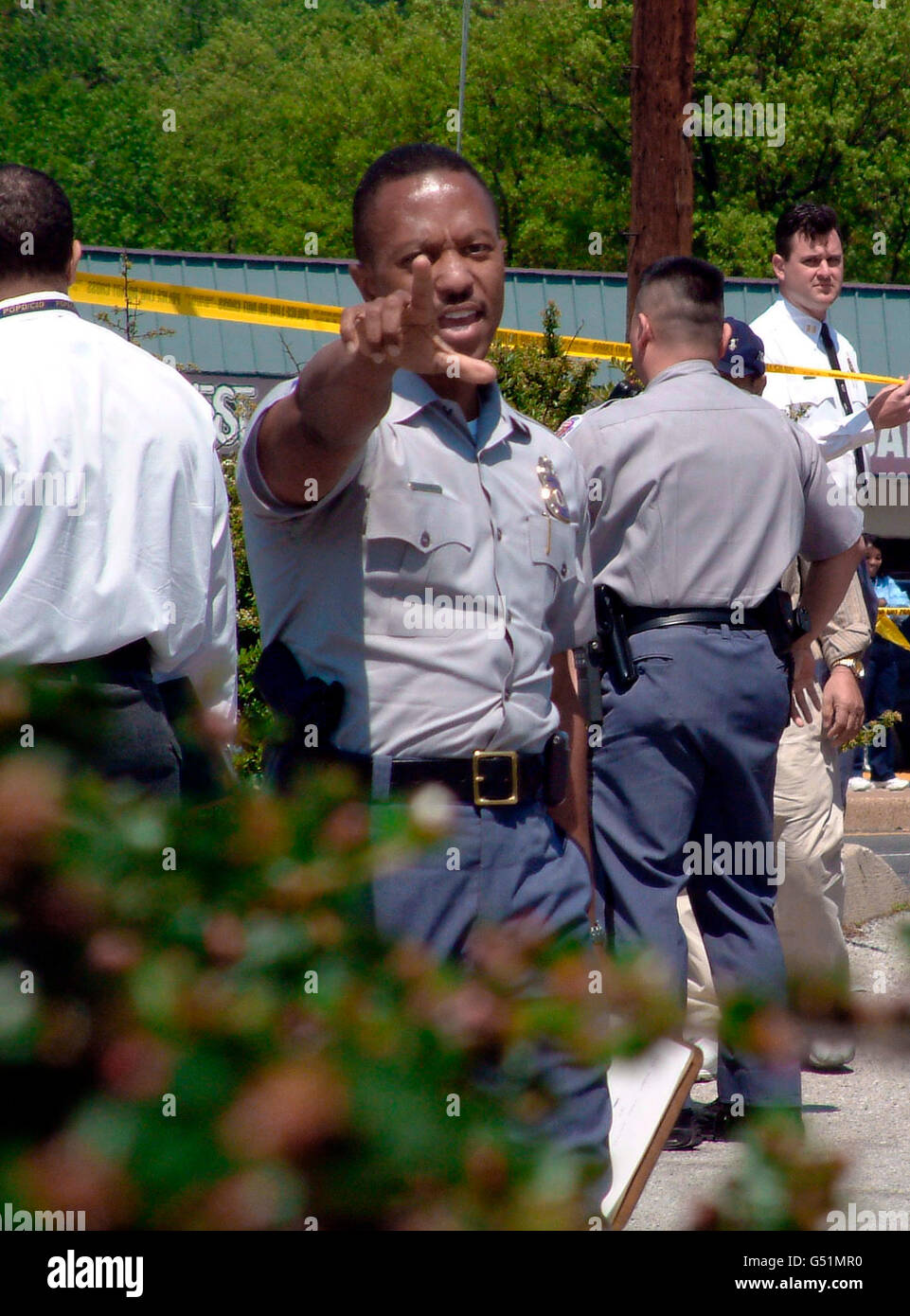 Policeman yelling at news photographers Stock Photo - Alamy