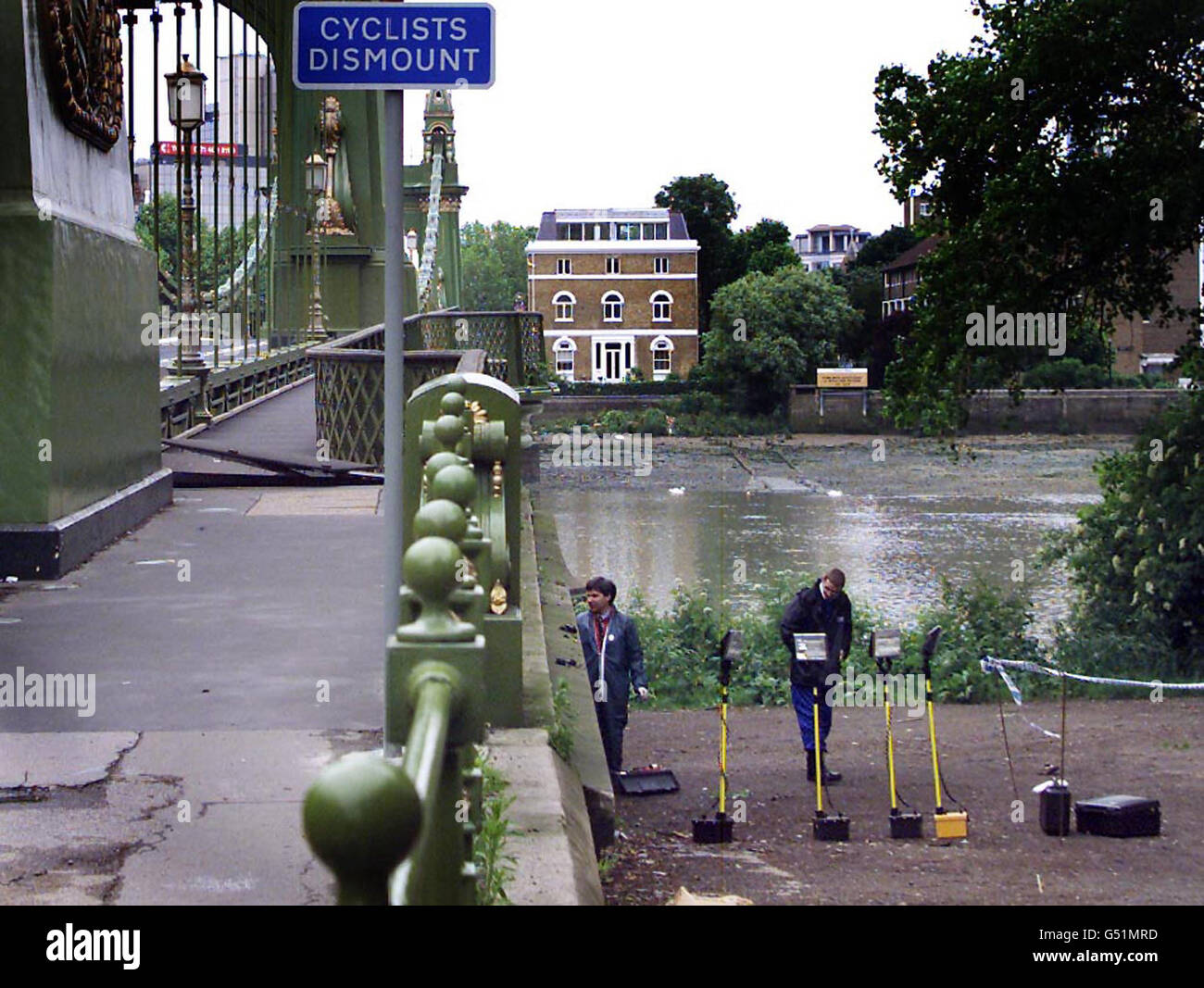 Police officers examine Hammersmith Bridge after a small bomb exploded ...