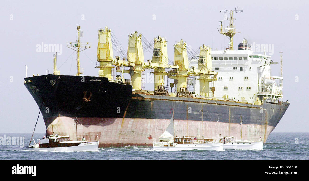 The procession of little ships pass by an oil tanker, on their journey ...