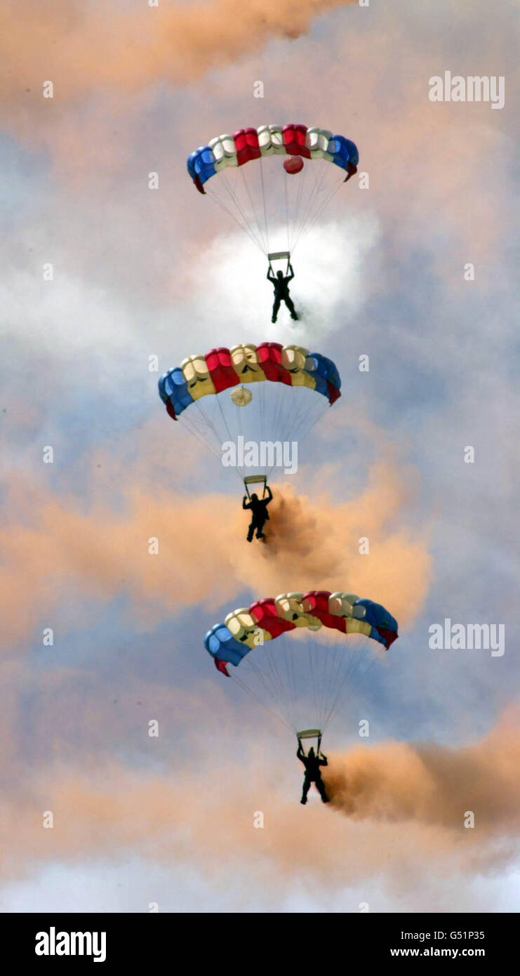 The RAF Falcons Freefall Team parachute through coloured smoke, during ...