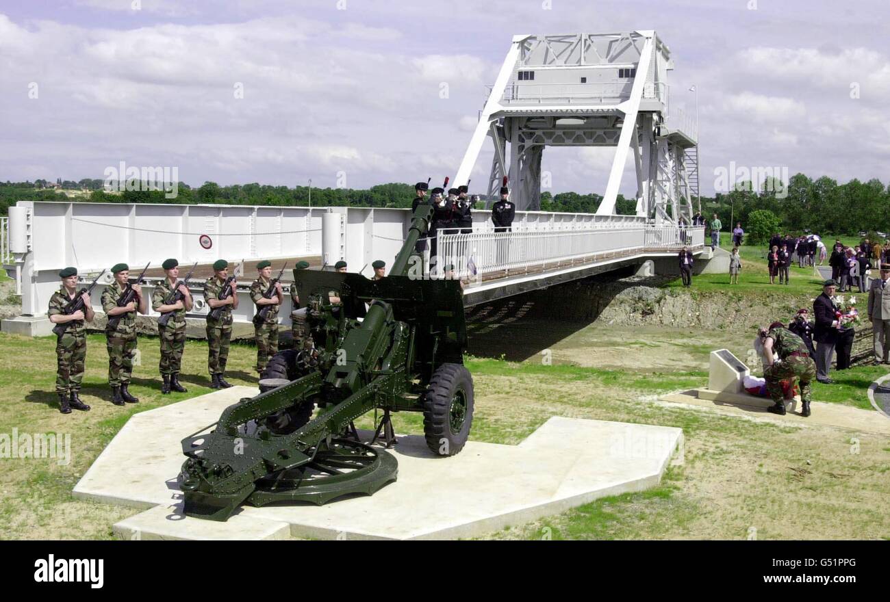 The Prince of Wales (right) lays a wreath at the Pegasus bridge ...