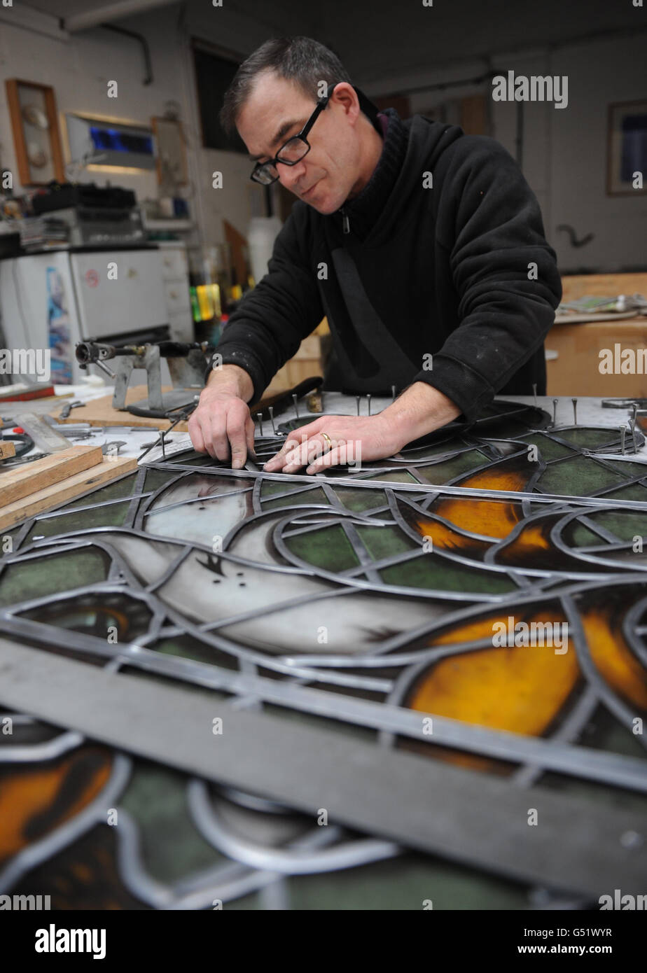 Glazier Tim Clarkson with the stained glass window that John Reyntiens ...