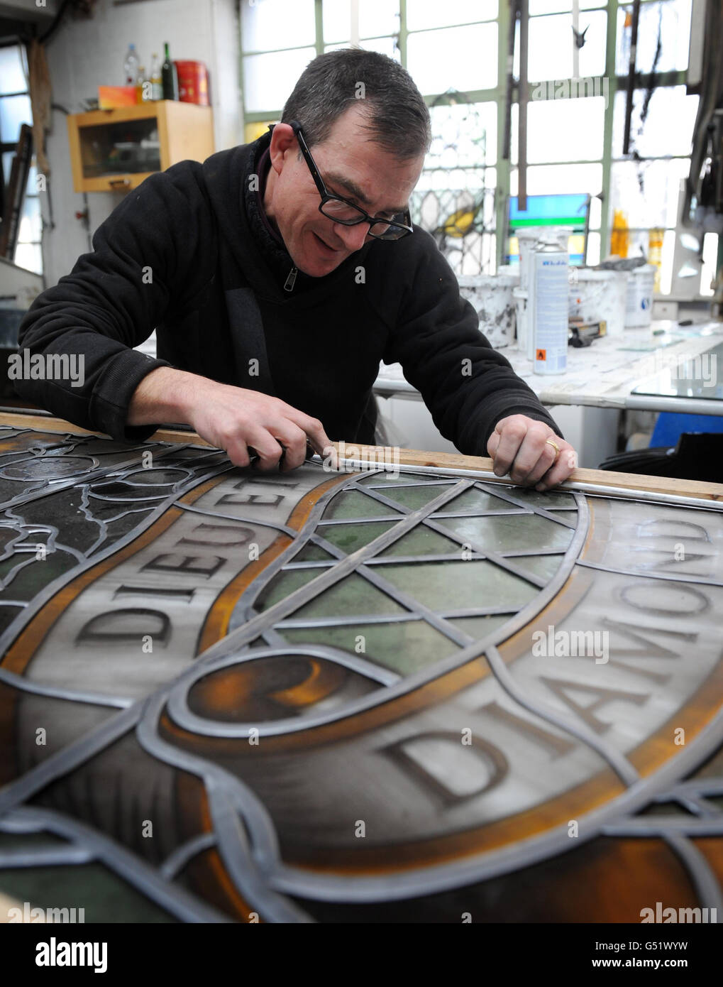 Glazier Tim Clarkson with the stained glass window that John Reyntiens ...