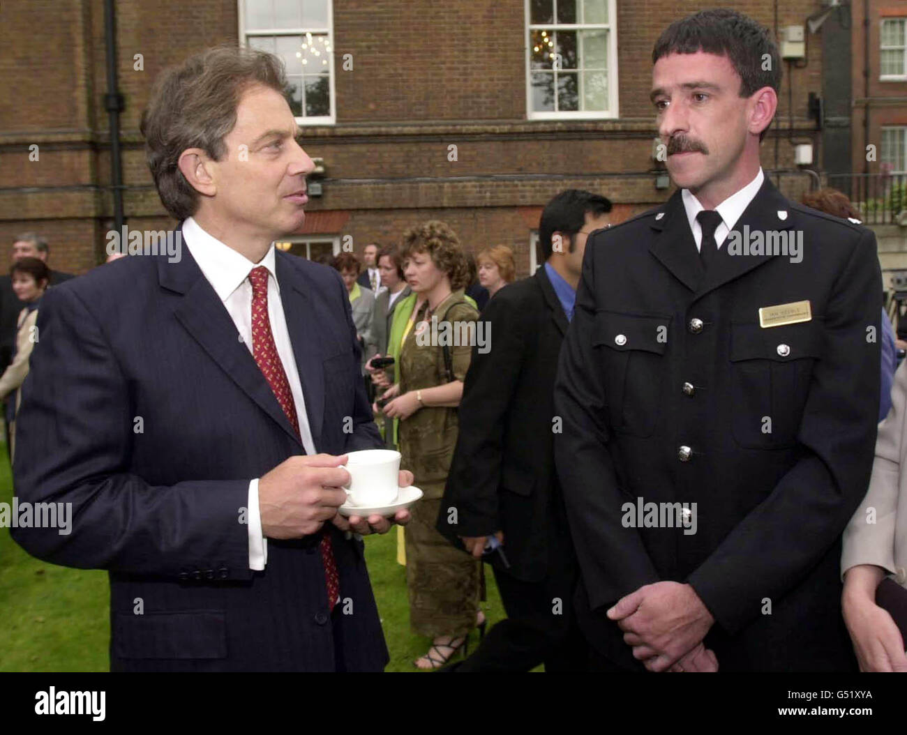 Prime Minister Tony Blair has a cup of tea while meeting police ...