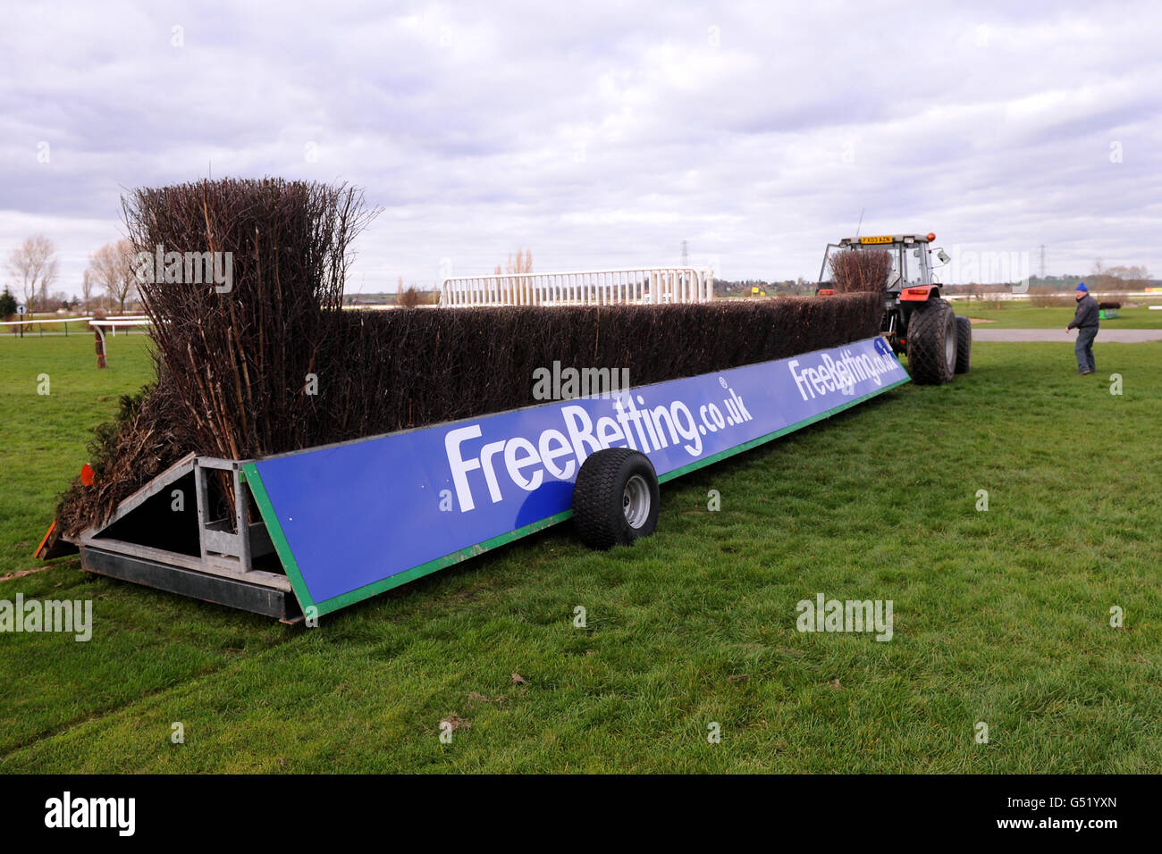 A Steeple Chase fence is moved out of position by tractor from the ...