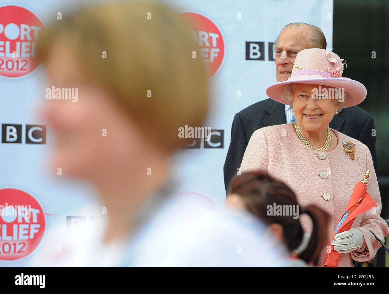 Queen Elizabeth II and the Duke of Edinburgh look on after waving the ...