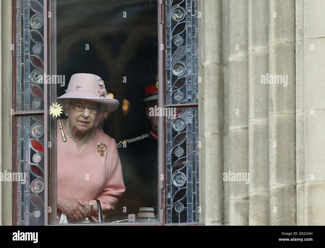 Queen Elizabeth II looks out of a window at Manchester Town Hall, prior ...
