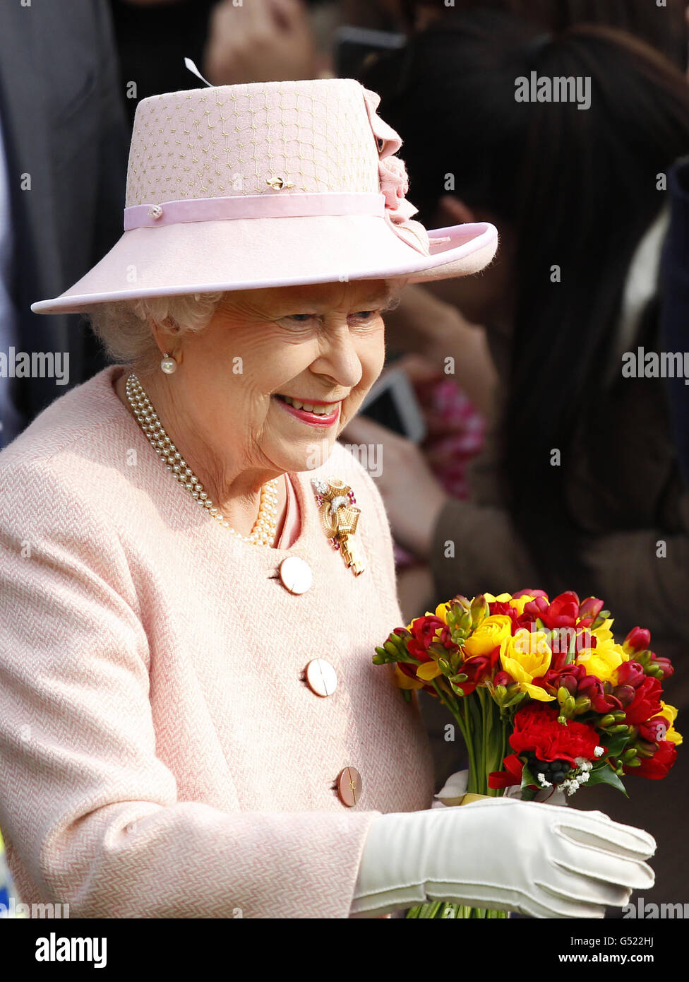 Queen Elizabeth II walks towards the crowd as she leaves Manchester ...
