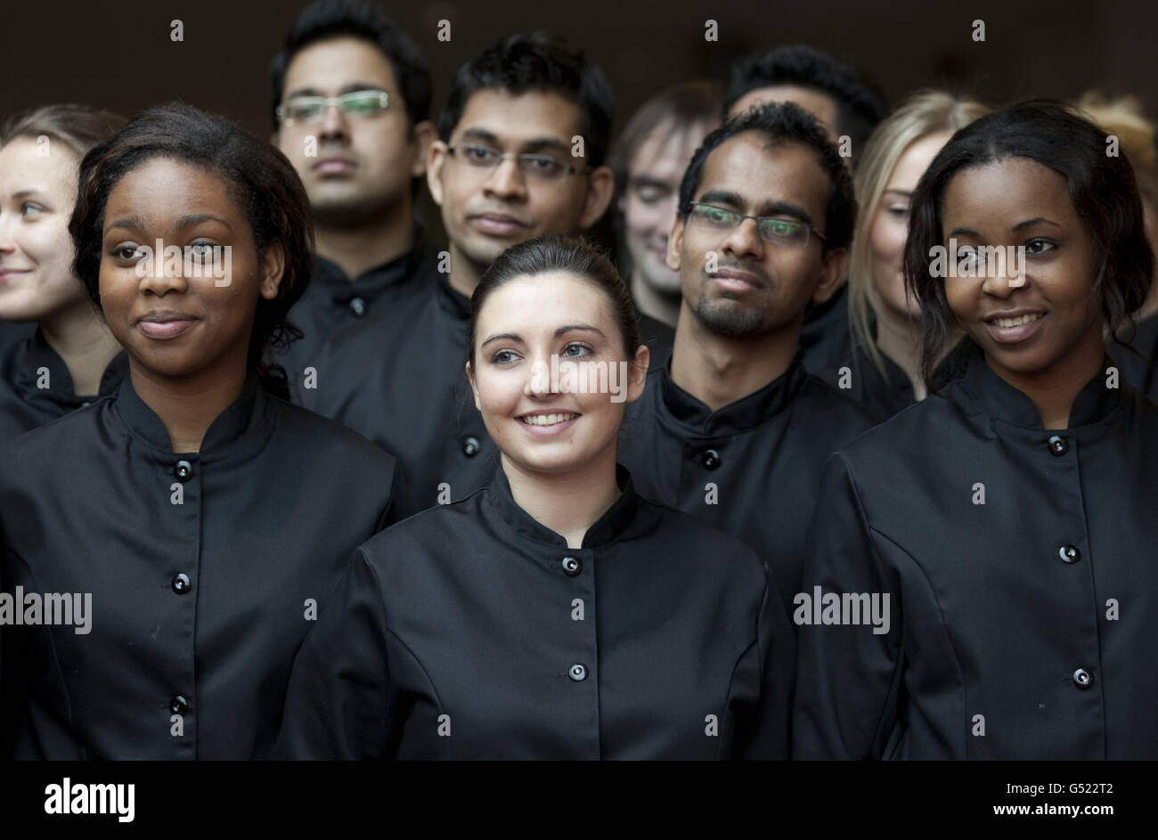 Staff members look on as Queen Elizabeth II visits the Manchester ...