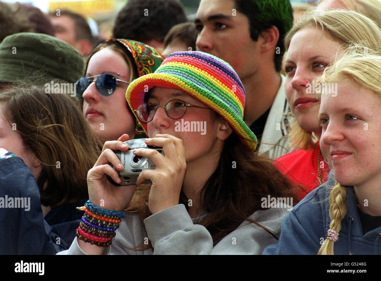 Glastonbury 2000 fans. A fan in the crowd taking pictures at the ...
