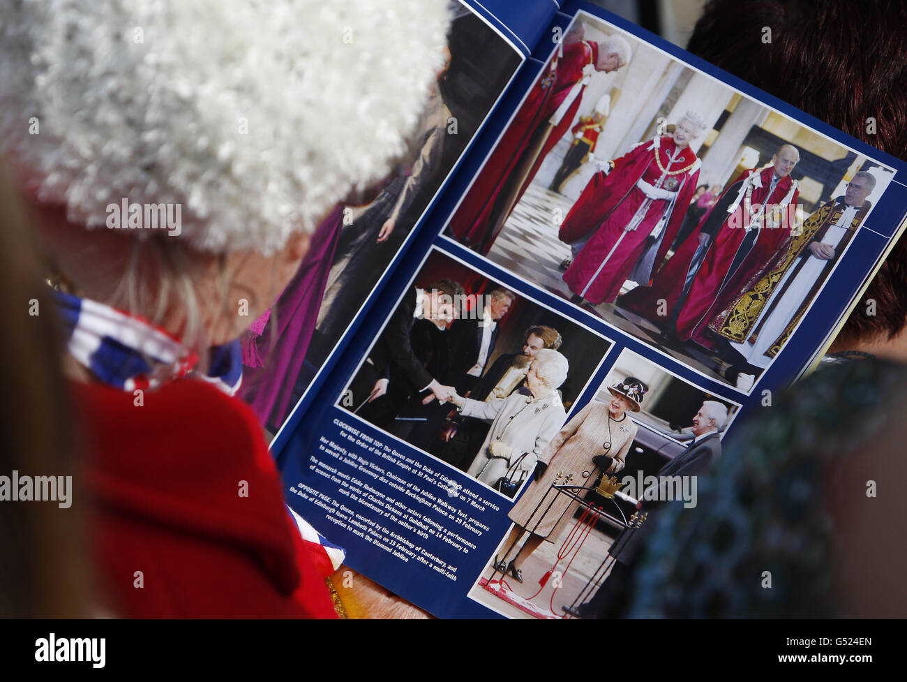 Stock image of a woman reading about the Royal Family as she waits for ...