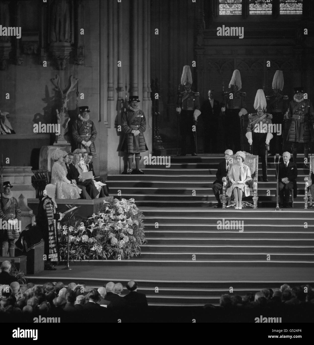 Queen Elizabeth II, listens as the Lord Chancellor, left, Lord Gardiner ...