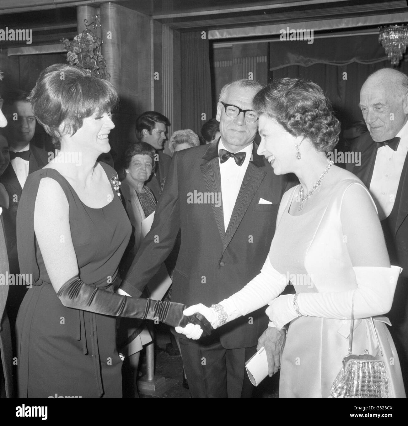Queen Elizabeth II is presented to Maggie Smith by Sir Laurence Olivier ...