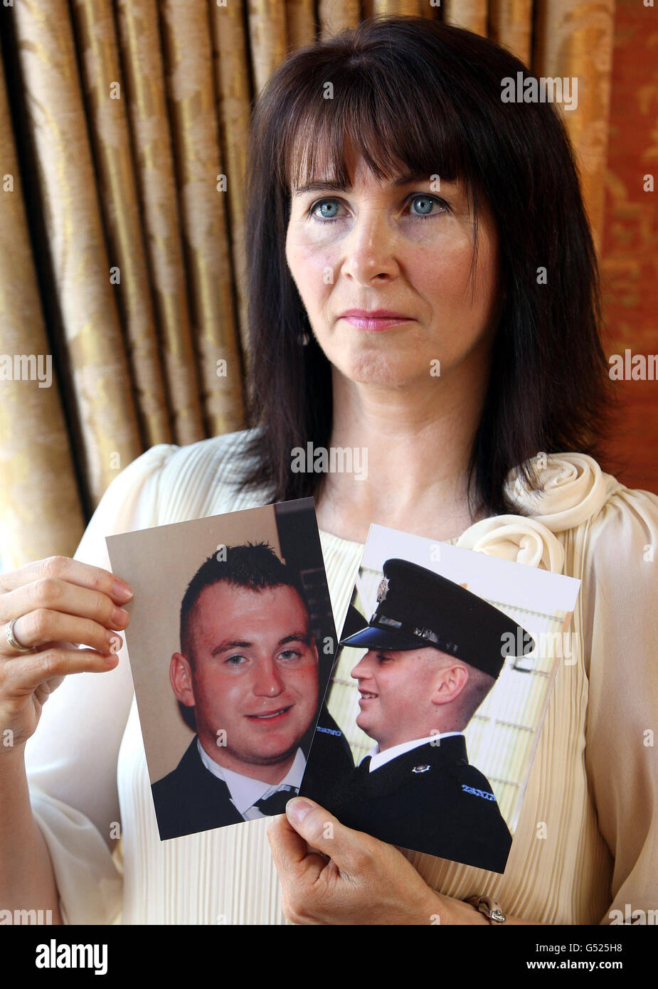 Nuala, mother of murdered Constable Ronan Kerr, holds photos of Ronan ...