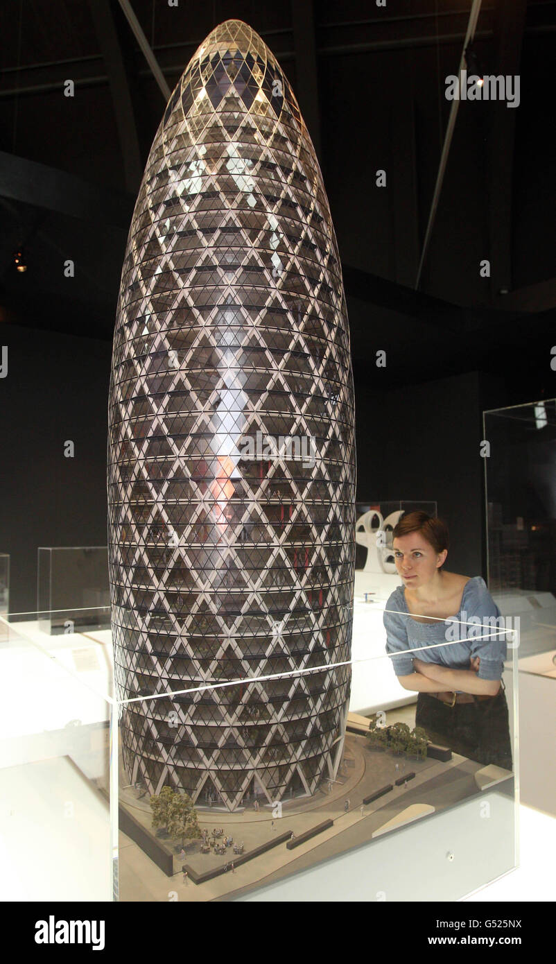 A gallery worker looks model of the Gherkin Building at the British ...