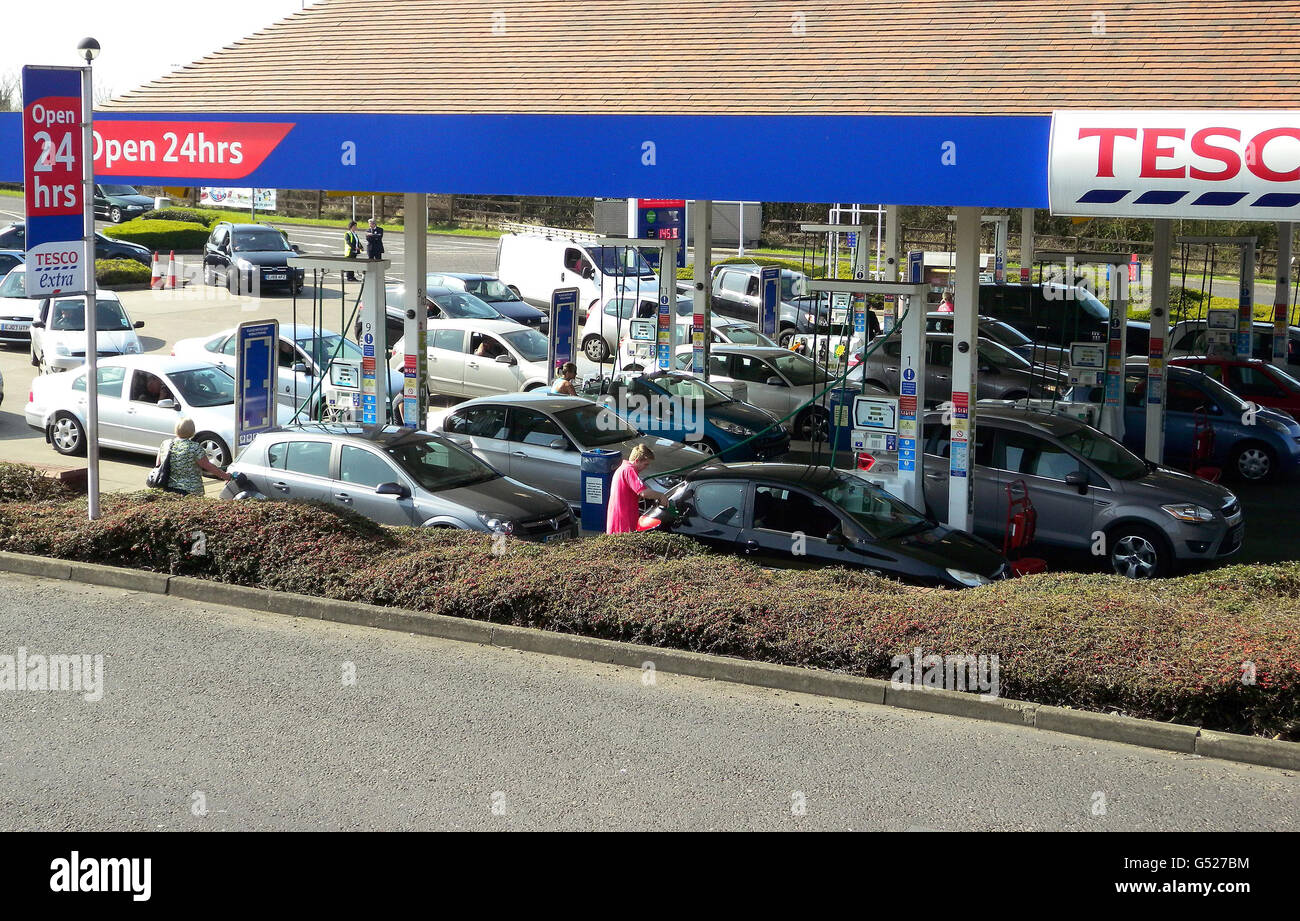 Cars queue for petrol at a Tesco petrol station at Mayflower Retail ...