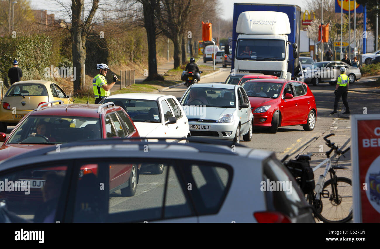 Police Community Support Officers manage the traffic queuing outside a ...