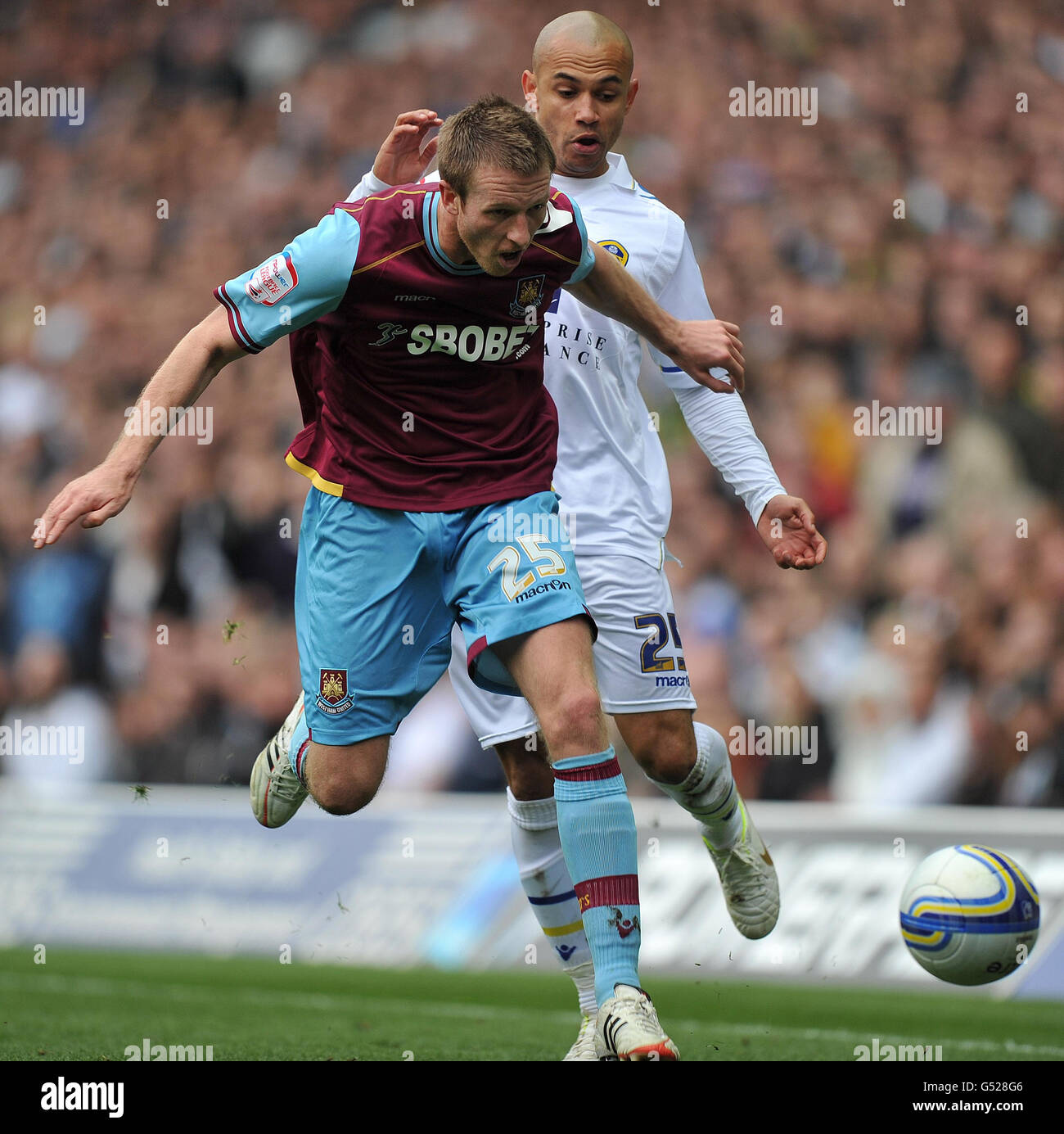Leeds United's Fabian Delph and West Ham United's Danny Collins chase ...