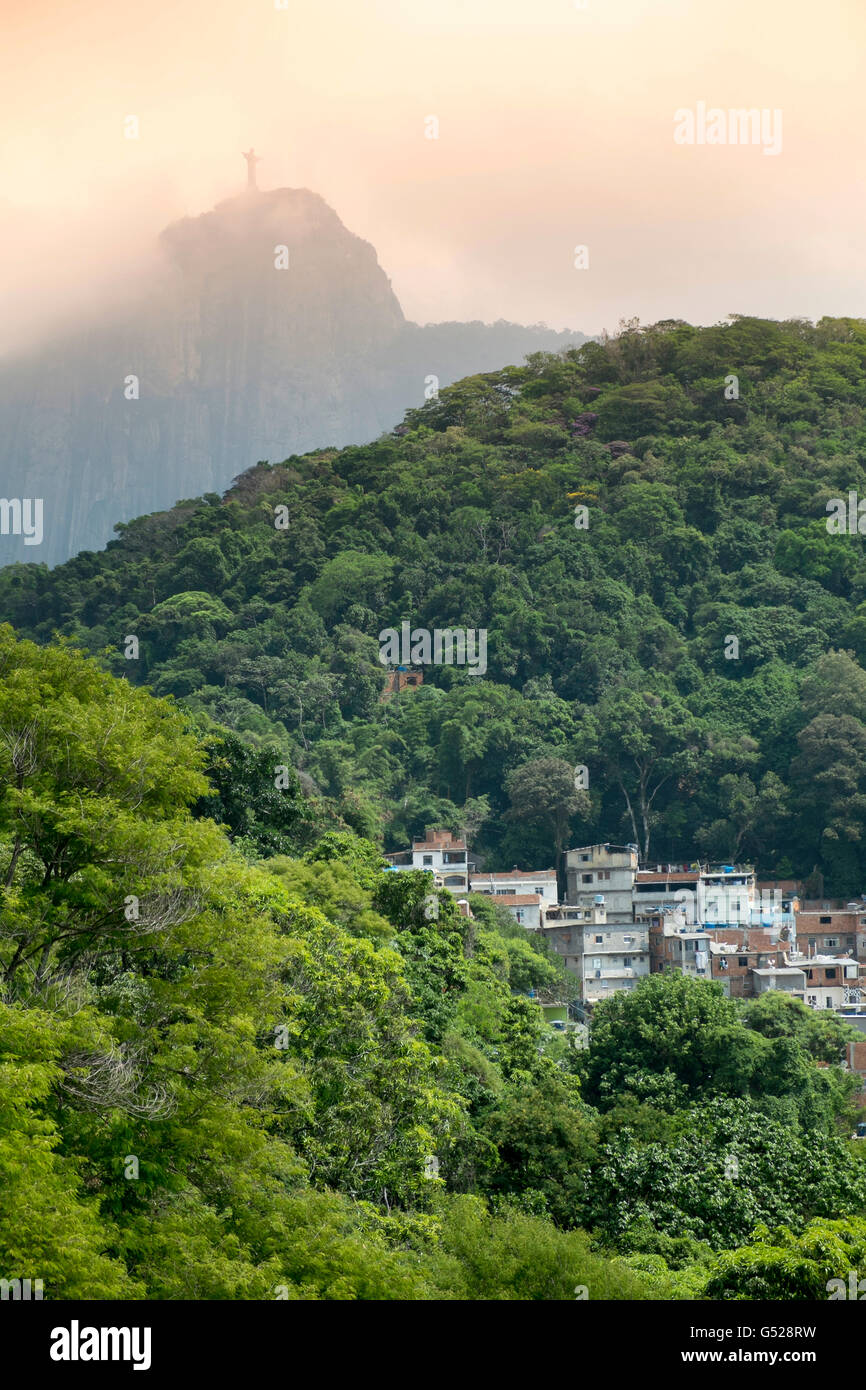 View of the Christ statue on Corcovado hill through mist, with favela ...