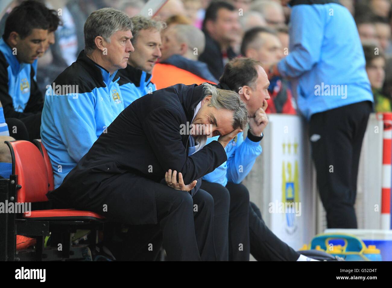Manchester city manager roberto mancini sat on the bench hi-res stock ...