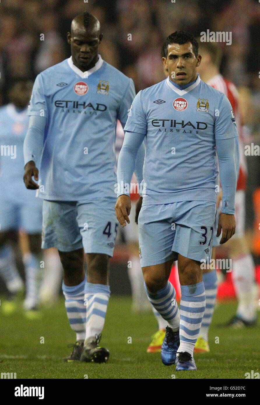 Manchester City's Mario Balotelli (left) and Carlos Tevez leave the ...