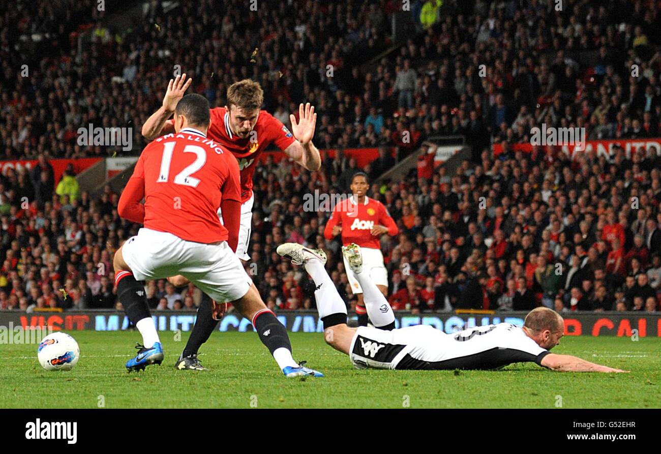 Fulham's Danny Murphy goes to ground after a challenge by Manchester ...