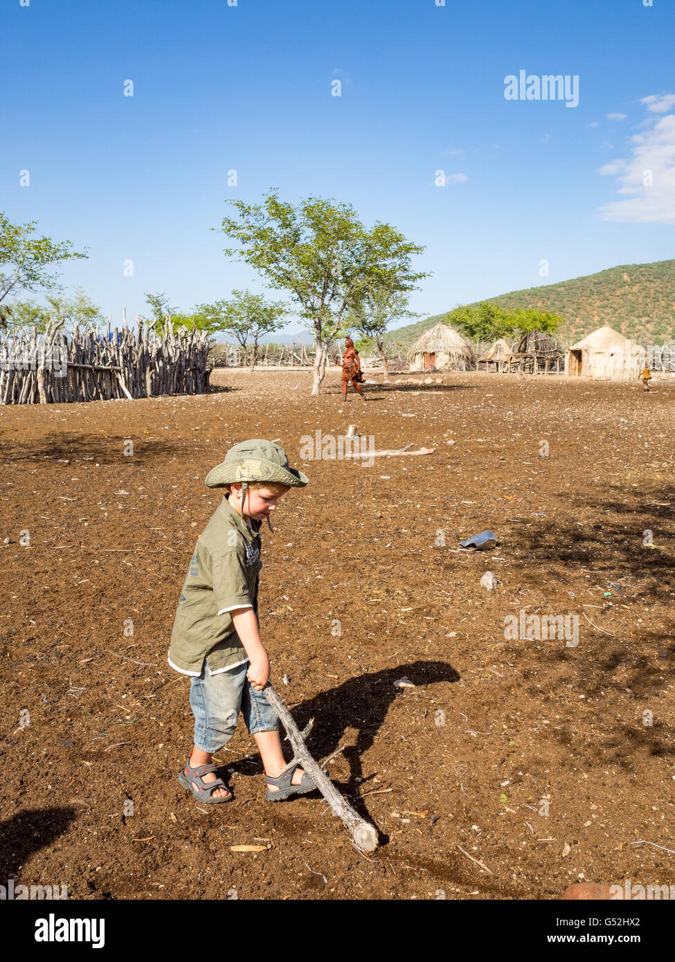 Namibia, Kunene, Kaokoland, German boy playing in the Himbakral ...