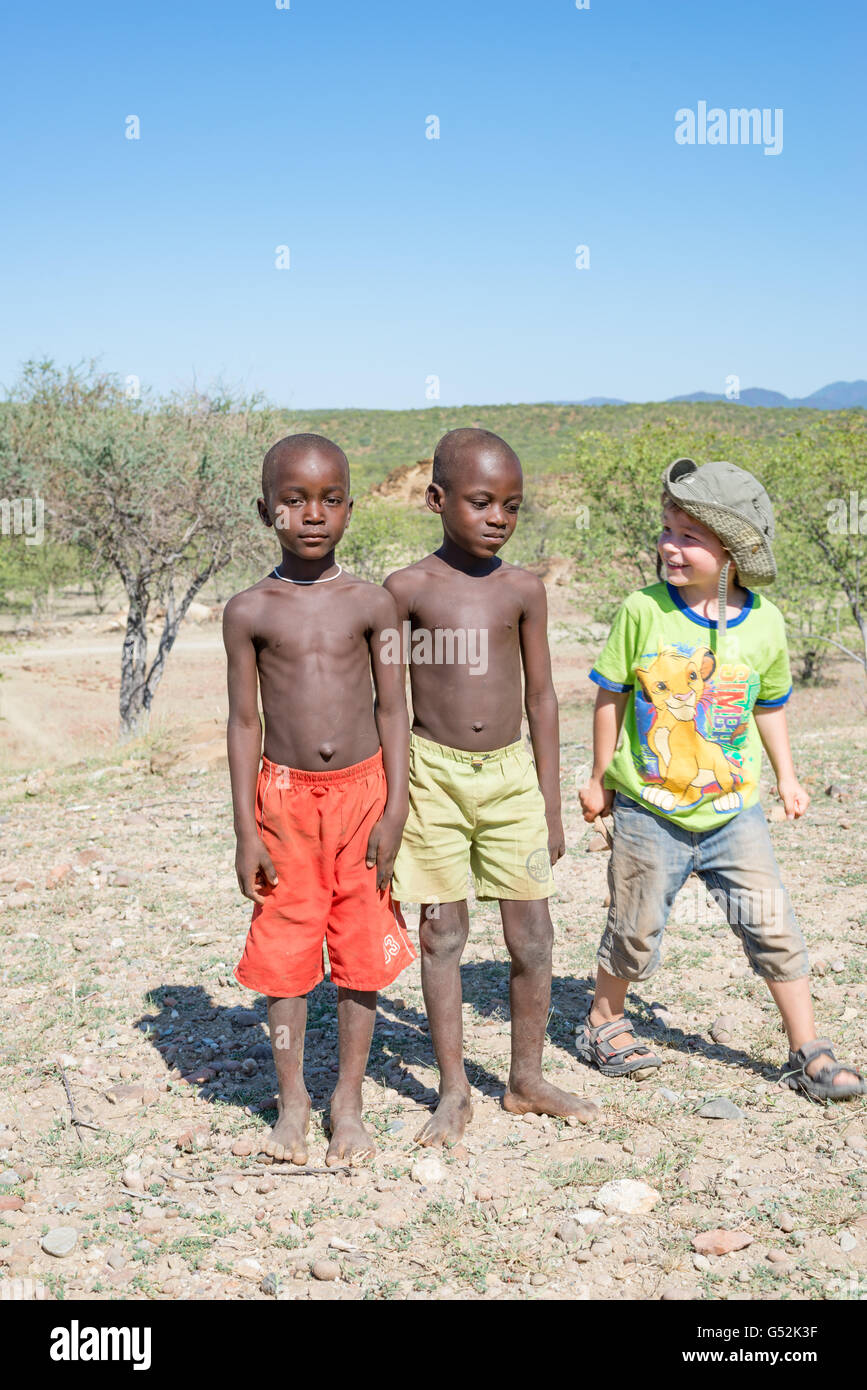 Namibia, Kunene, Kaokoland, German boy under Himba boys Stock Photo - Alamy
